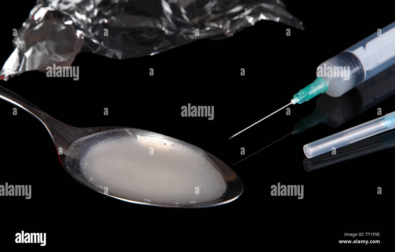 Heroin in spoon on black background Stock Photo - Alamy