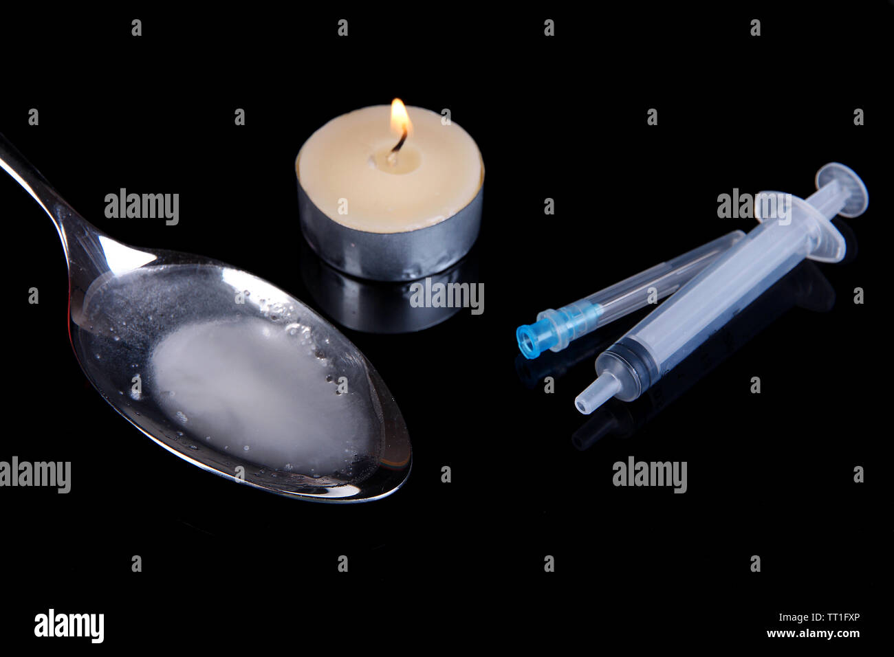 Heroin in spoon on black background Stock Photo - Alamy