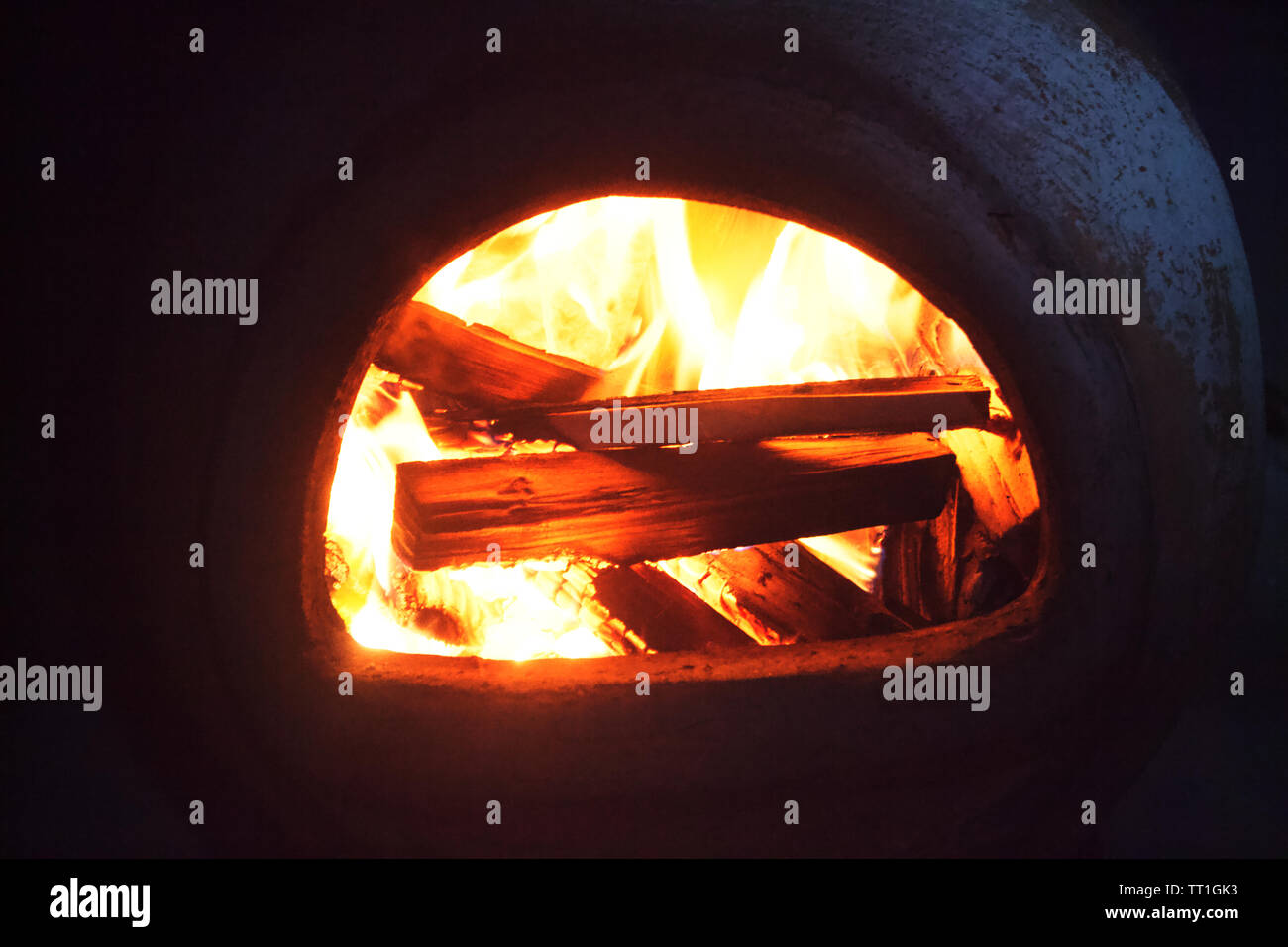 Red fire glow as wood burns in a chimnea on a cold night Stock Photo ...