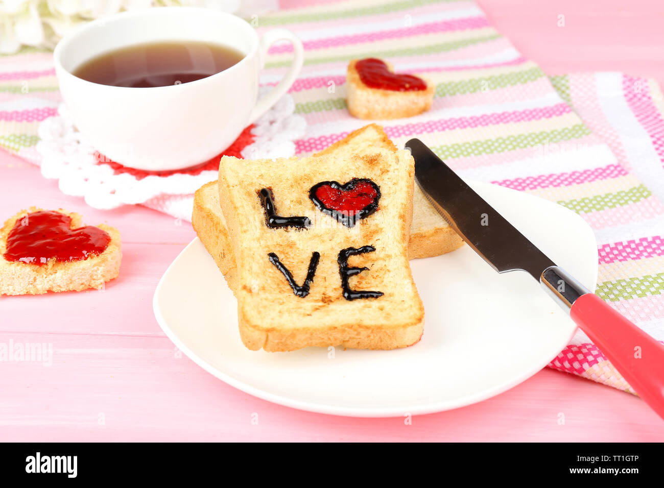 Delicious toast with jam and cup of tea on table close-up Stock Photo ...