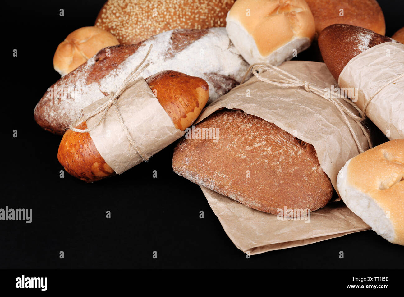 Different types of bread on black background, close-up Stock Photo - Alamy