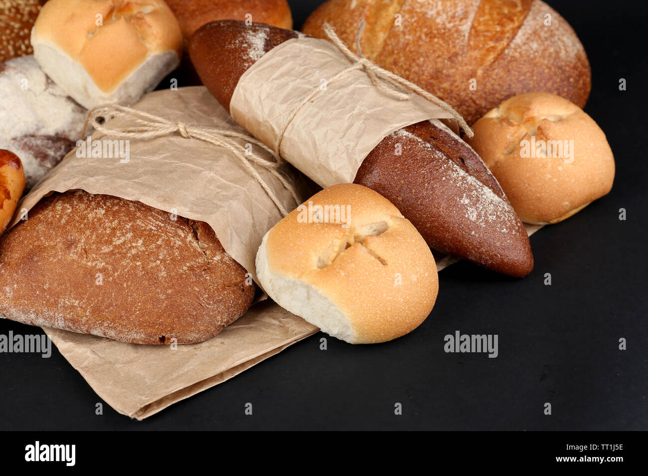 Different types of bread on black background, close-up Stock Photo - Alamy