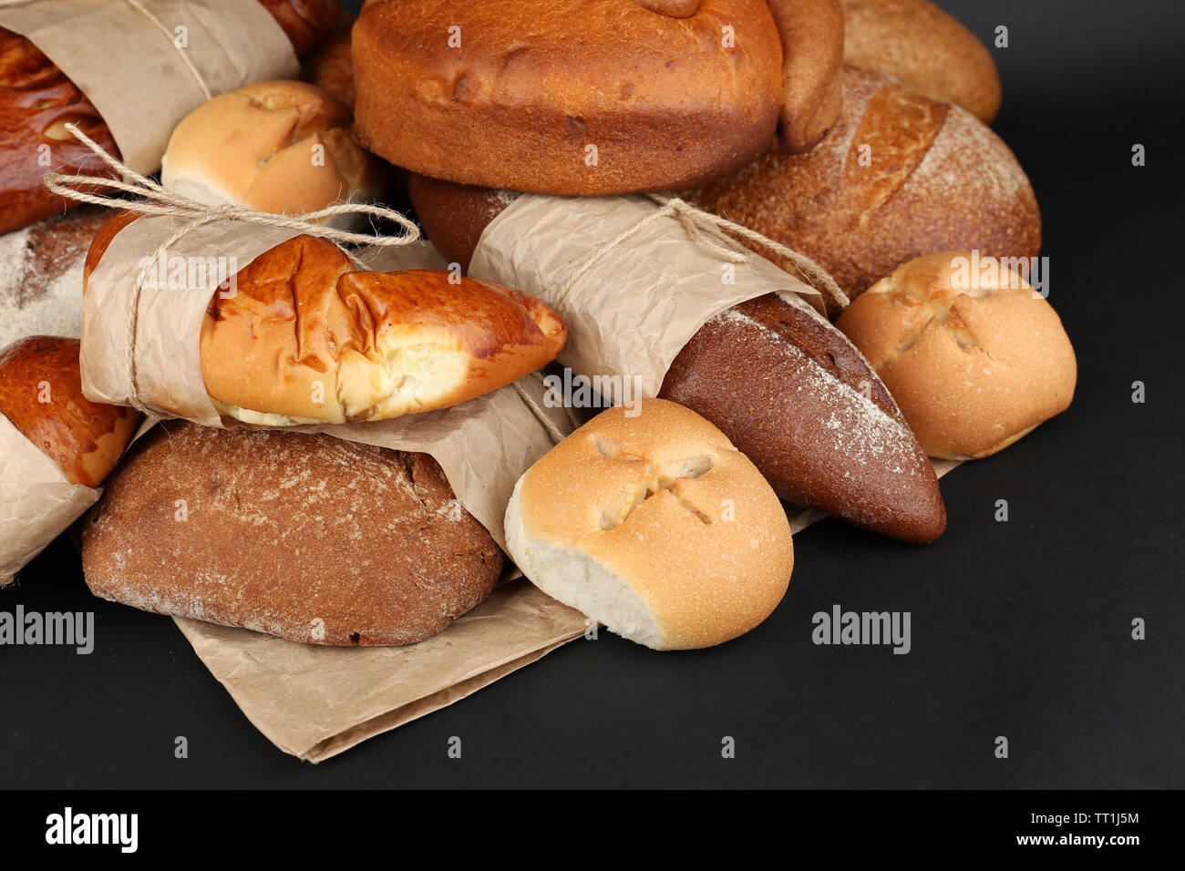 Different types of bread on black background, close-up Stock Photo - Alamy
