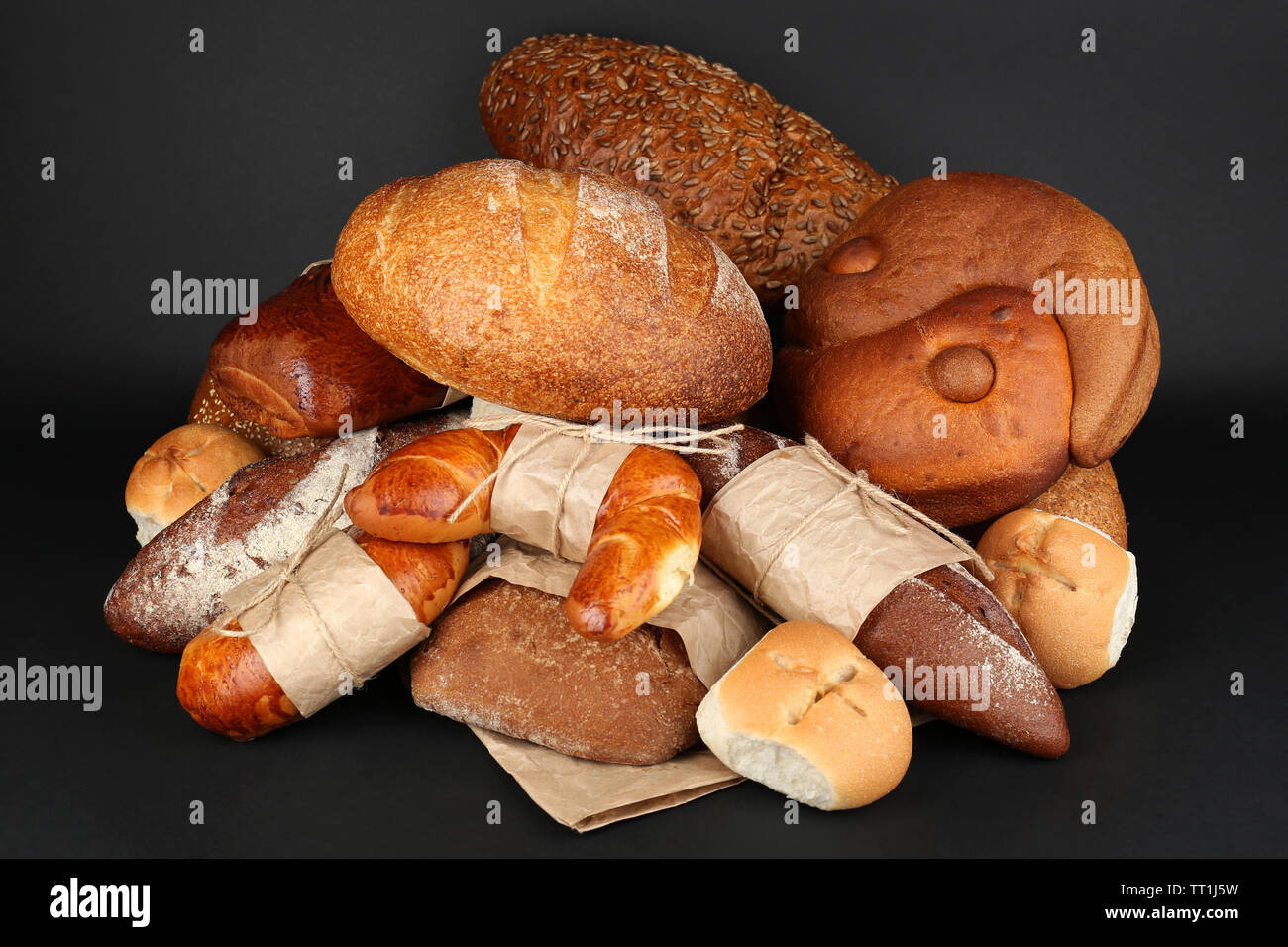 Different types of bread on black background, close-up Stock Photo - Alamy