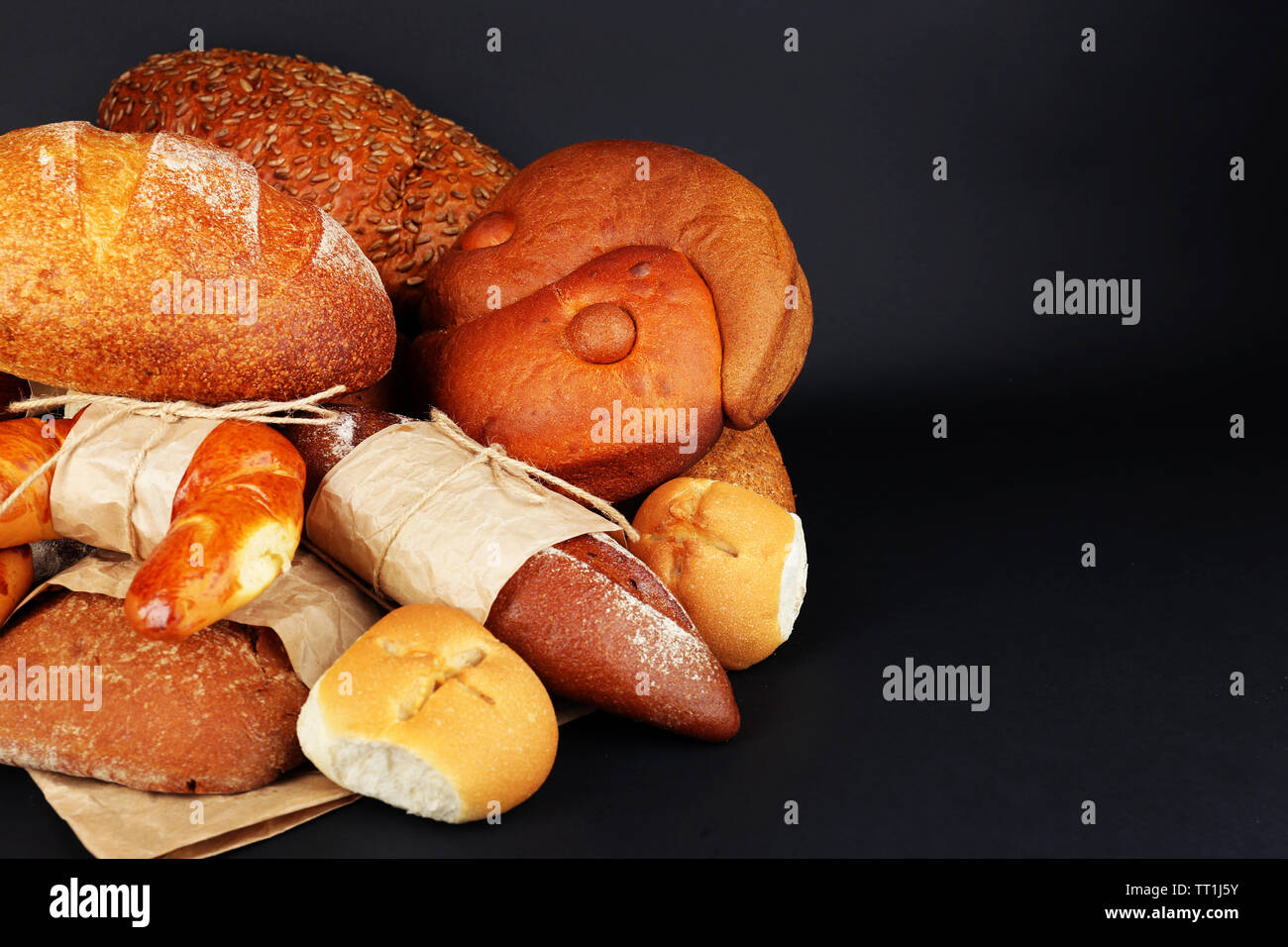 Different types of bread on black background, close-up Stock Photo - Alamy