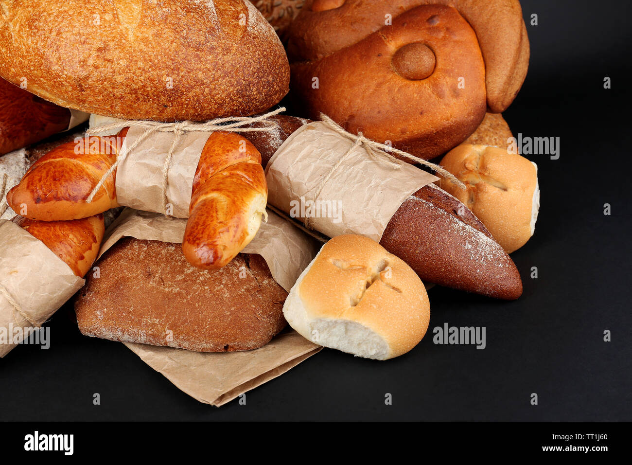 Different types of bread on black background, close-up Stock Photo - Alamy