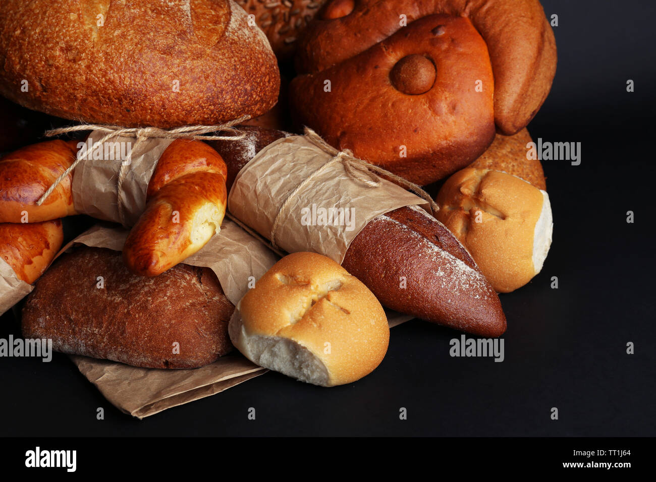 Different types of bread on black background, close-up Stock Photo - Alamy