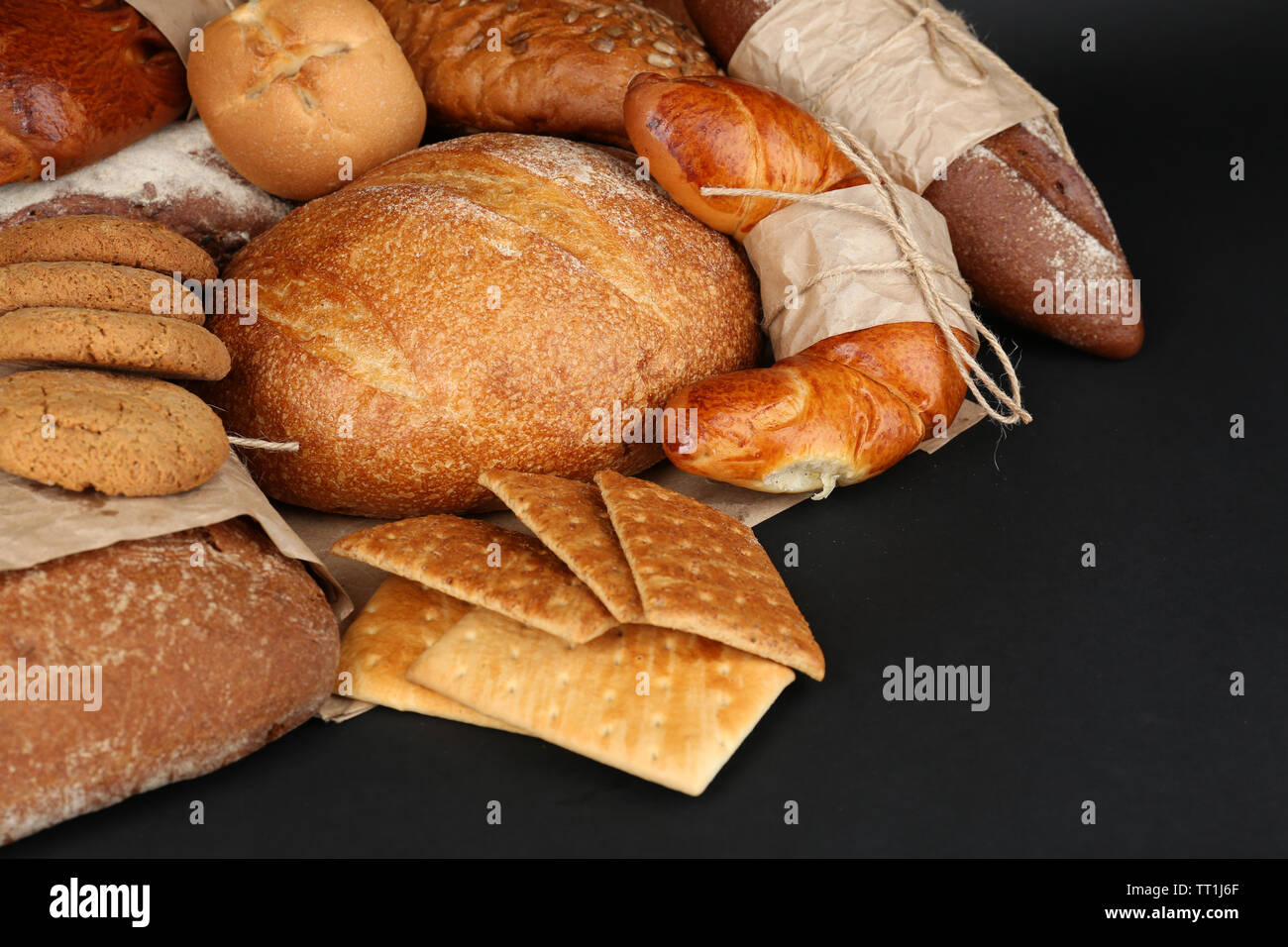 Different types of bread on black background, close-up Stock Photo - Alamy