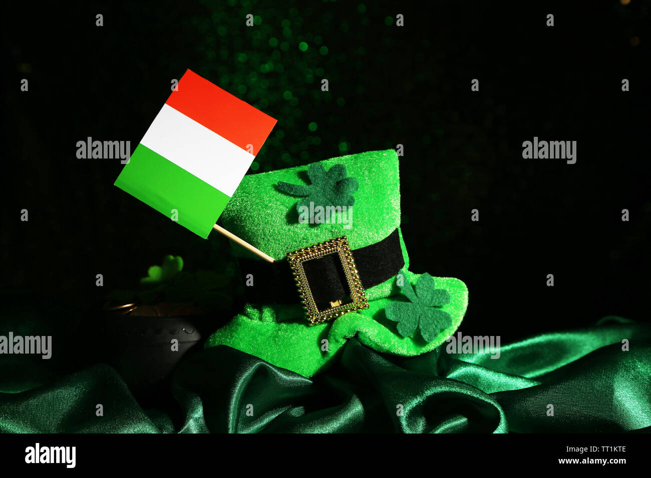 Saint Patrick day hat, pot of gold coins and Irish flag on black shiny ...