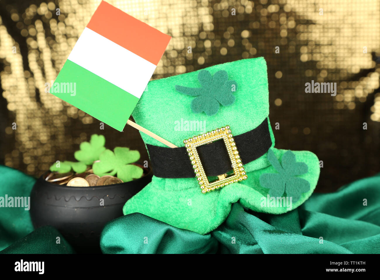 Saint Patrick day hat, pot of gold coins and Irish flag on shiny ...