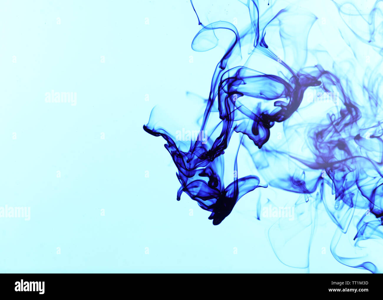 Ink in water on blue background Stock Photo - Alamy