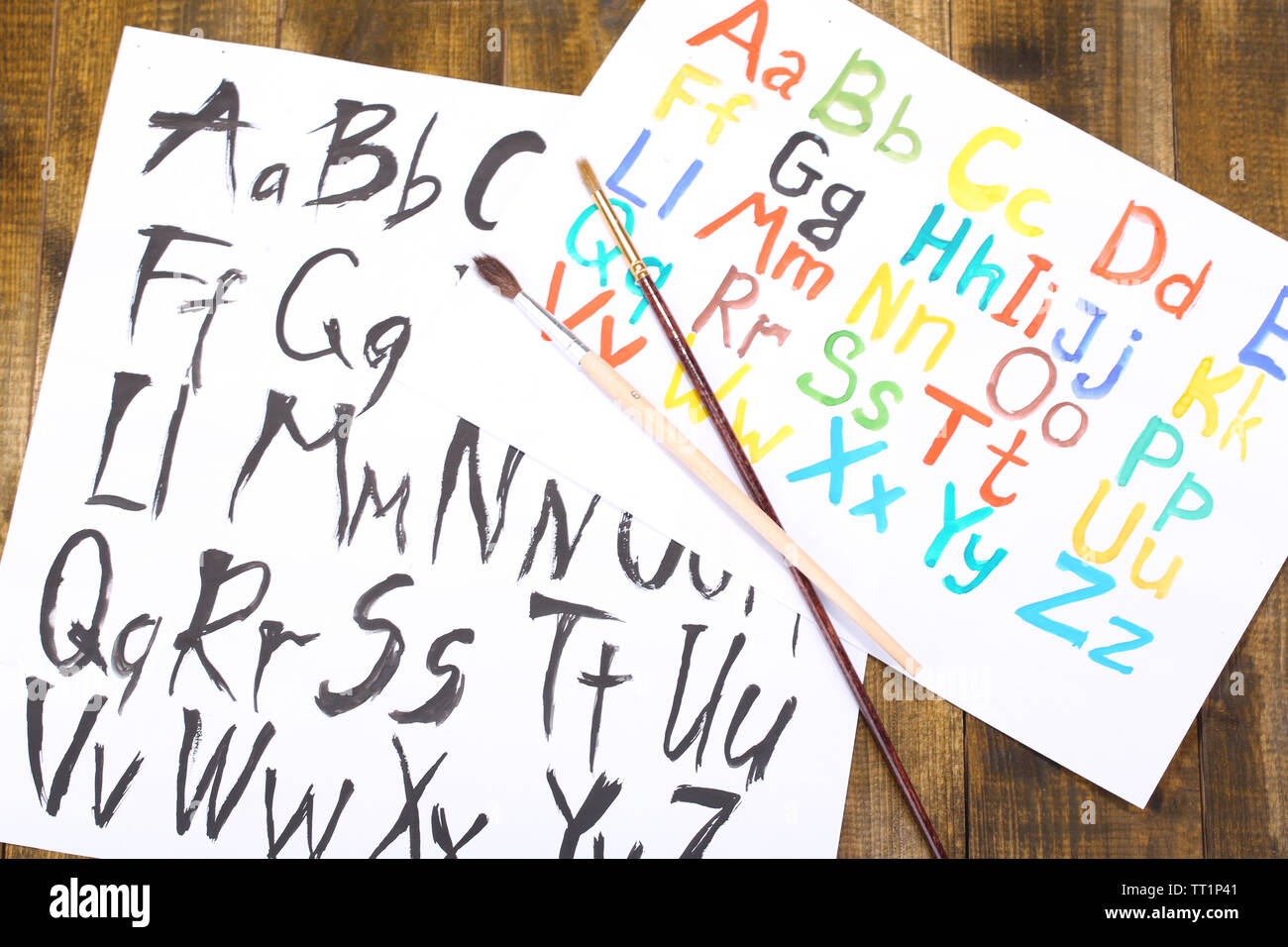 Alphabet watercolors on wooden background Stock Photo - Alamy