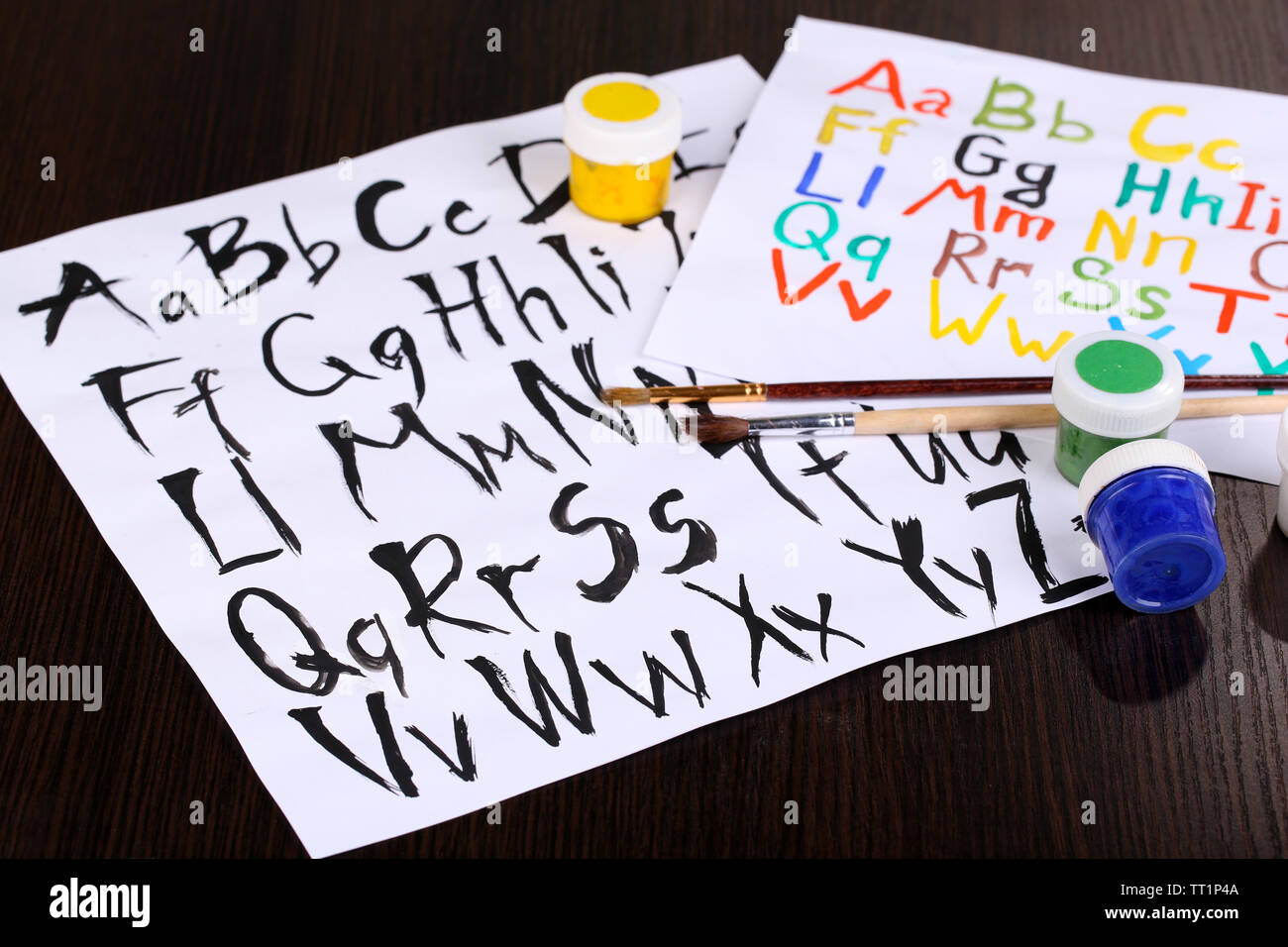 Alphabet watercolors on wooden background Stock Photo - Alamy