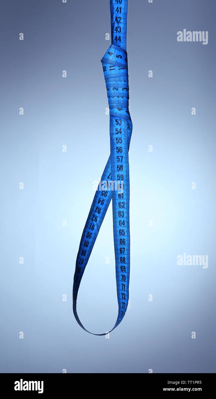 Tape measure noose on blue background - diet concept Stock Photo - Alamy