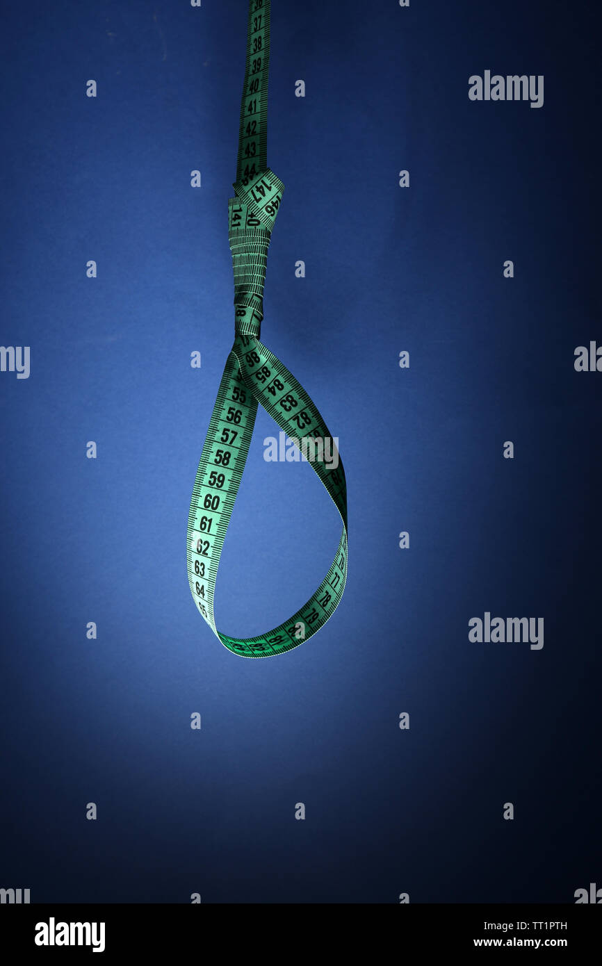 Tape measure noose on blue background - diet concept Stock Photo - Alamy