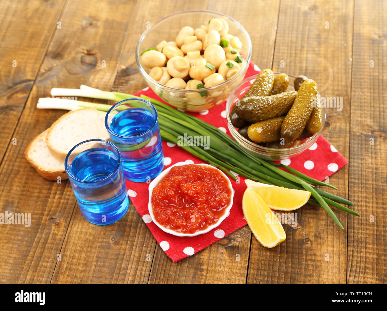 Composition with glass of vodka and marinated mushrooms, cucumbers on ...