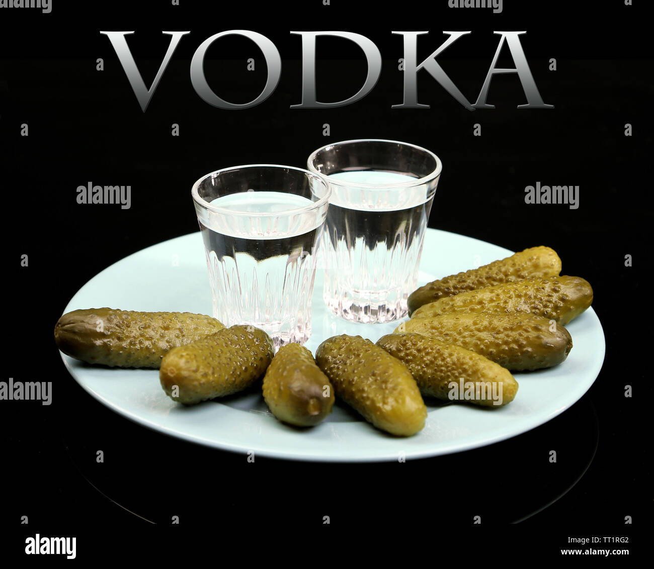 Composition with glass of vodka and snacks on color plate, isolated on ...
