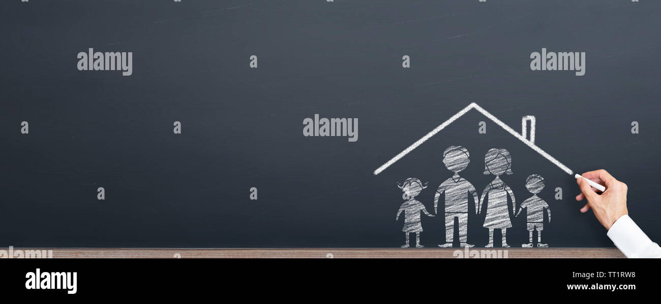 man is drawing roof on the family on chalkboard. home ownership concept ...