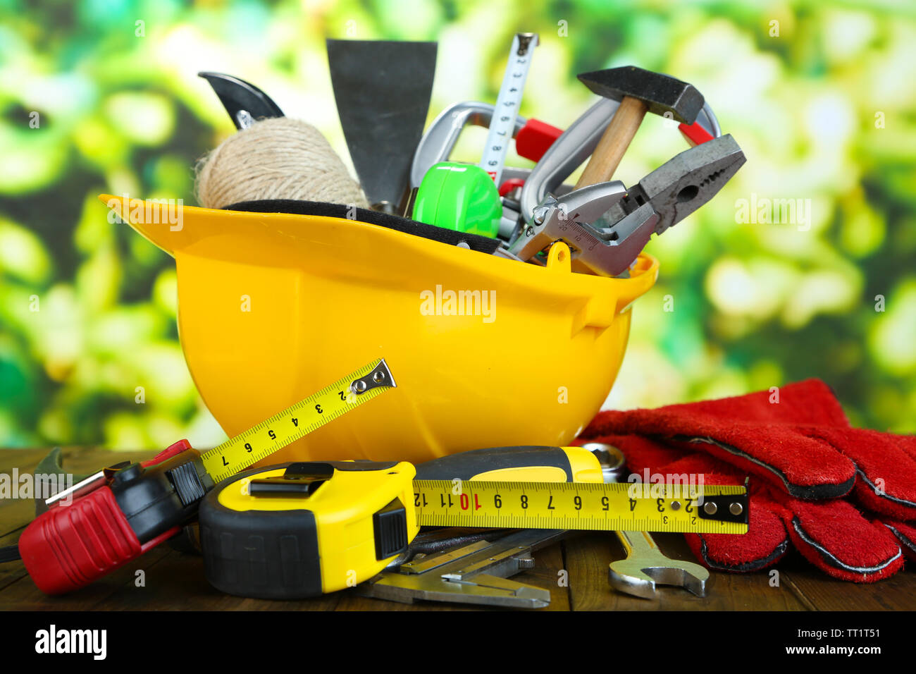Construction equipment on wooden table, on bright background Stock ...