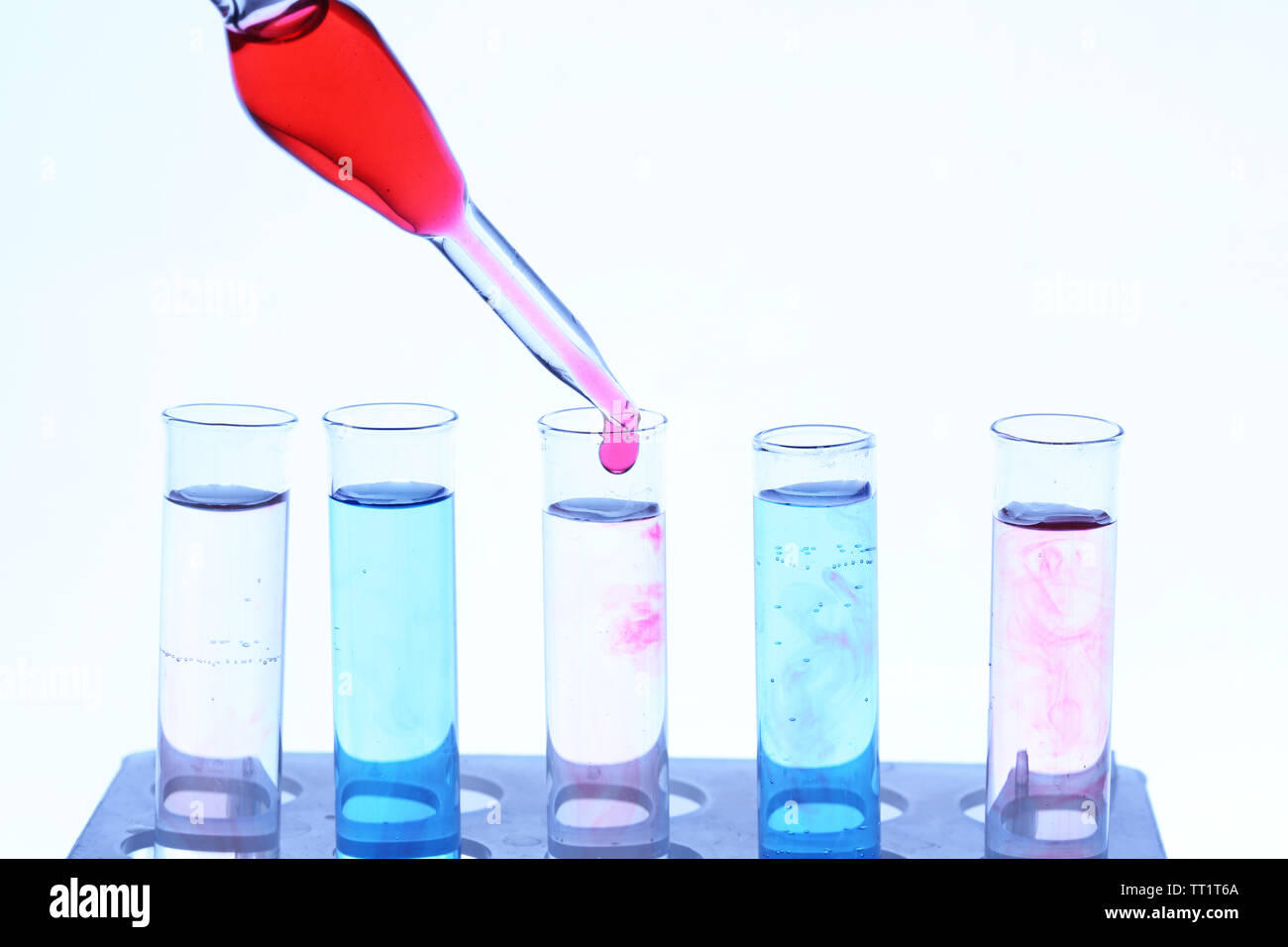 Scientist adding liquid test tubes hi-res stock photography and images ...