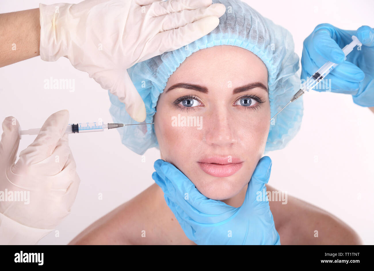 Woman in beauty clinic getting botox injection, isolated on white Stock ...