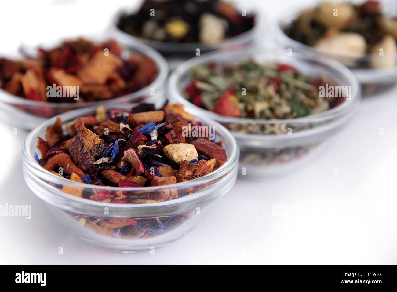Different kinds of dry tea in bowls close up Stock Photo - Alamy