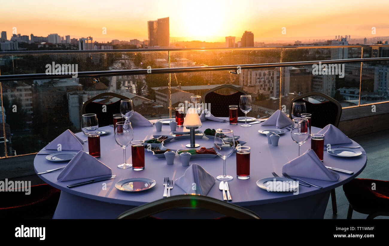 fancy sunset table on roof tea time Stock Photo - Alamy