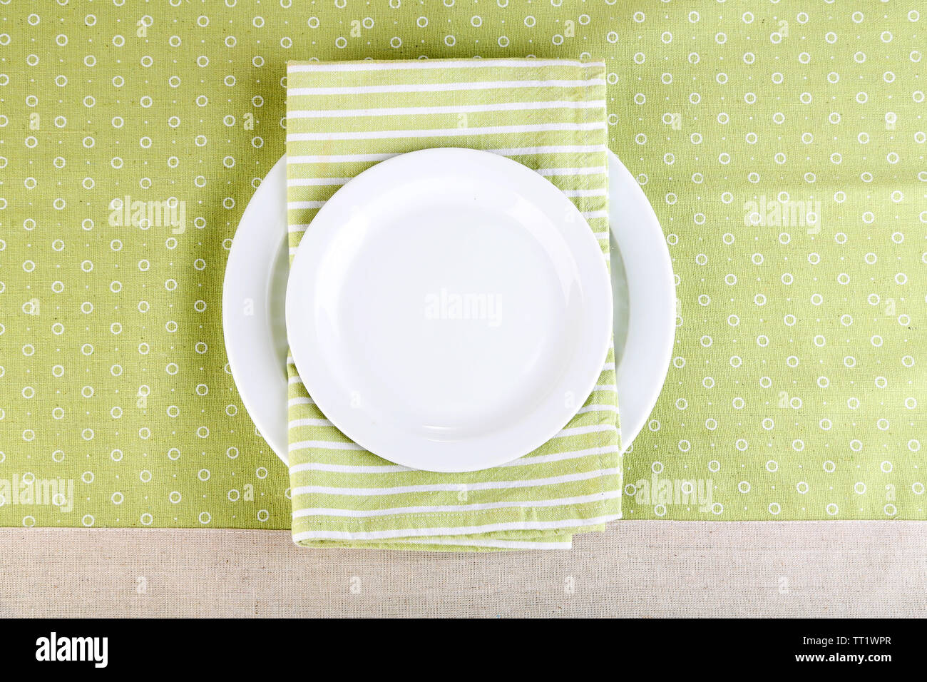 Table setting on colorful tablecloth background Stock Photo - Alamy
