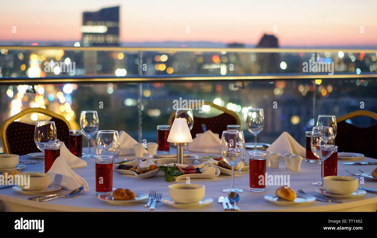 fancy sunset table on roof tea time Stock Photo - Alamy