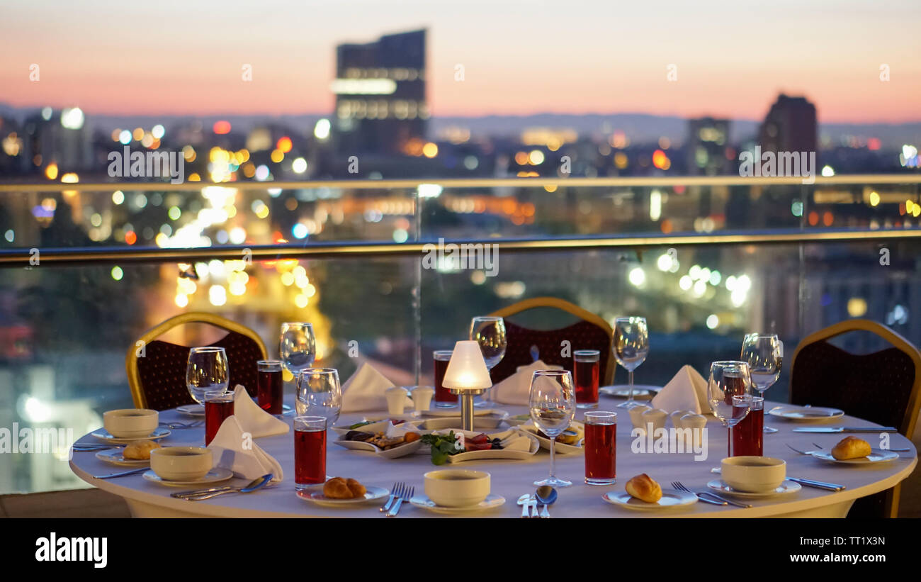 fancy sunset table on roof tea time Stock Photo - Alamy