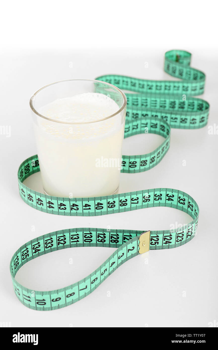 Glass of milk with measuring tape isolated on white Stock Photo - Alamy