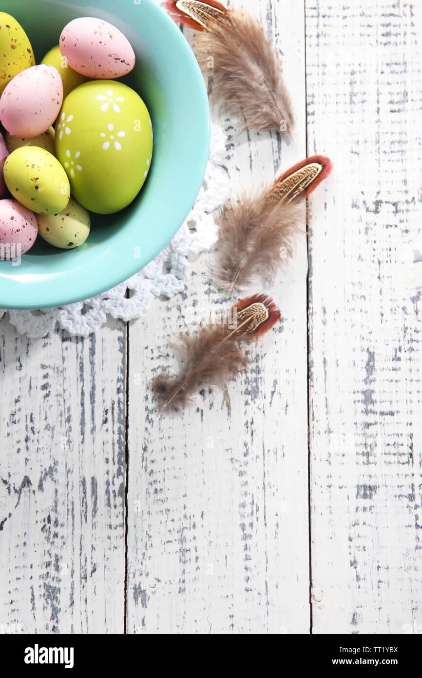 Easter eggs in color bowl on color wooden background Stock Photo - Alamy