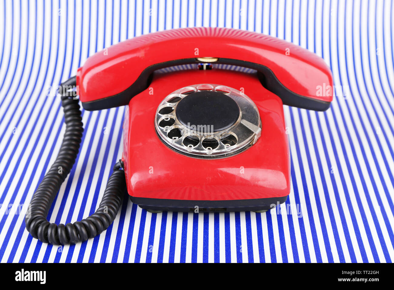 Red retro telephone on bright background Stock Photo - Alamy
