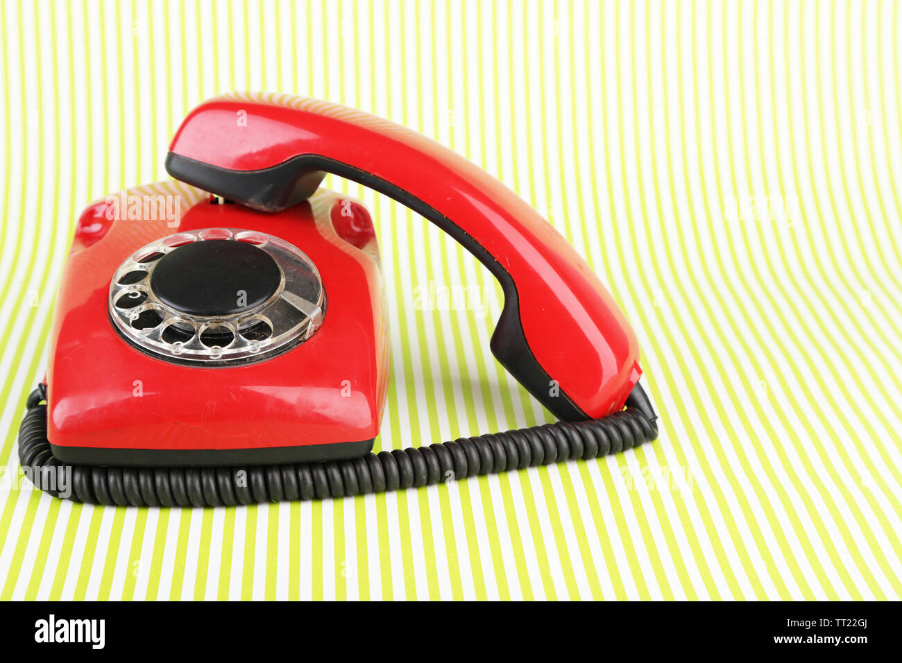 Red retro telephone on bright background Stock Photo - Alamy