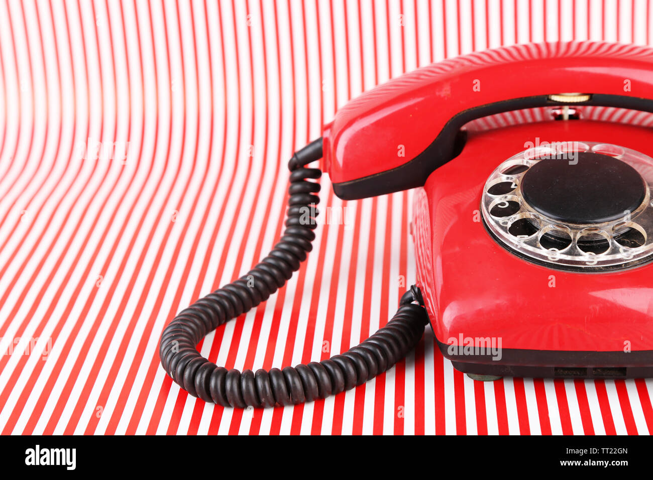 Red retro telephone on bright background Stock Photo - Alamy