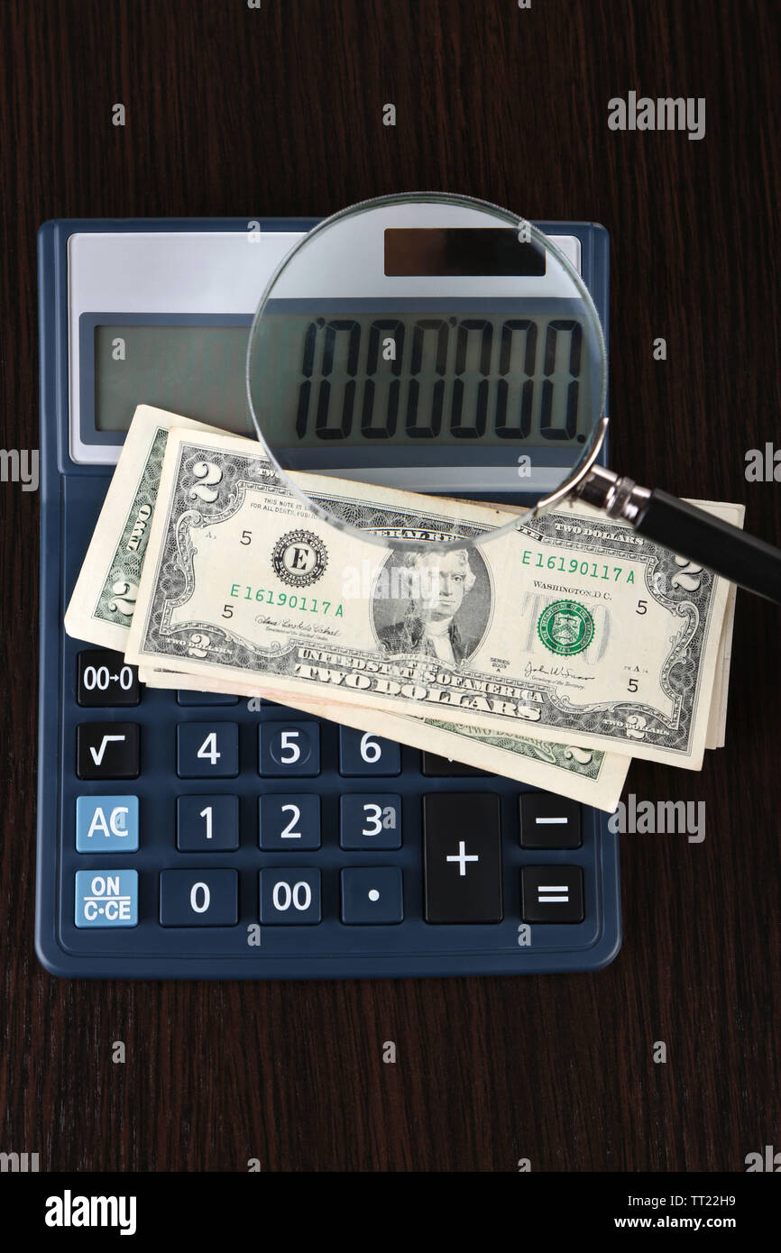 Fraud concept with magnifier and calculator, on wooden background Stock ...