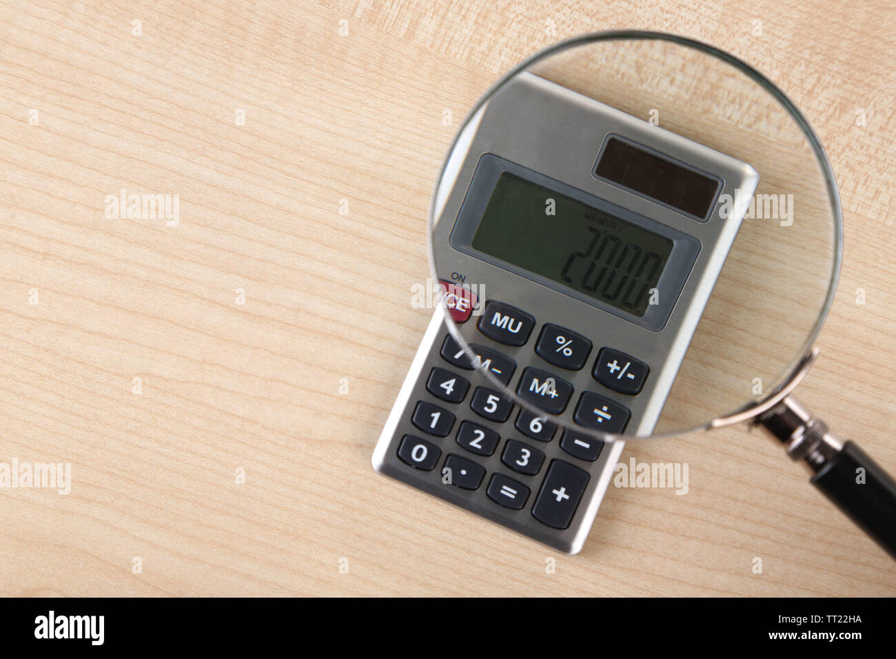 Fraud concept with magnifier and calculator, on wooden background Stock ...