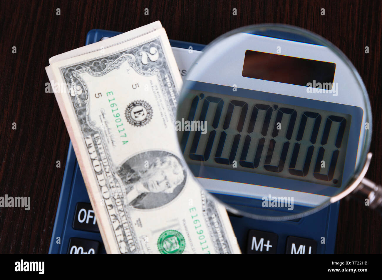 Fraud concept with magnifier and calculator, on wooden background Stock ...