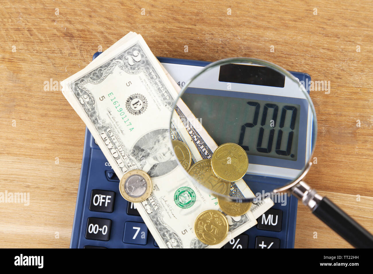 Fraud concept with magnifier and calculator, on wooden background Stock ...