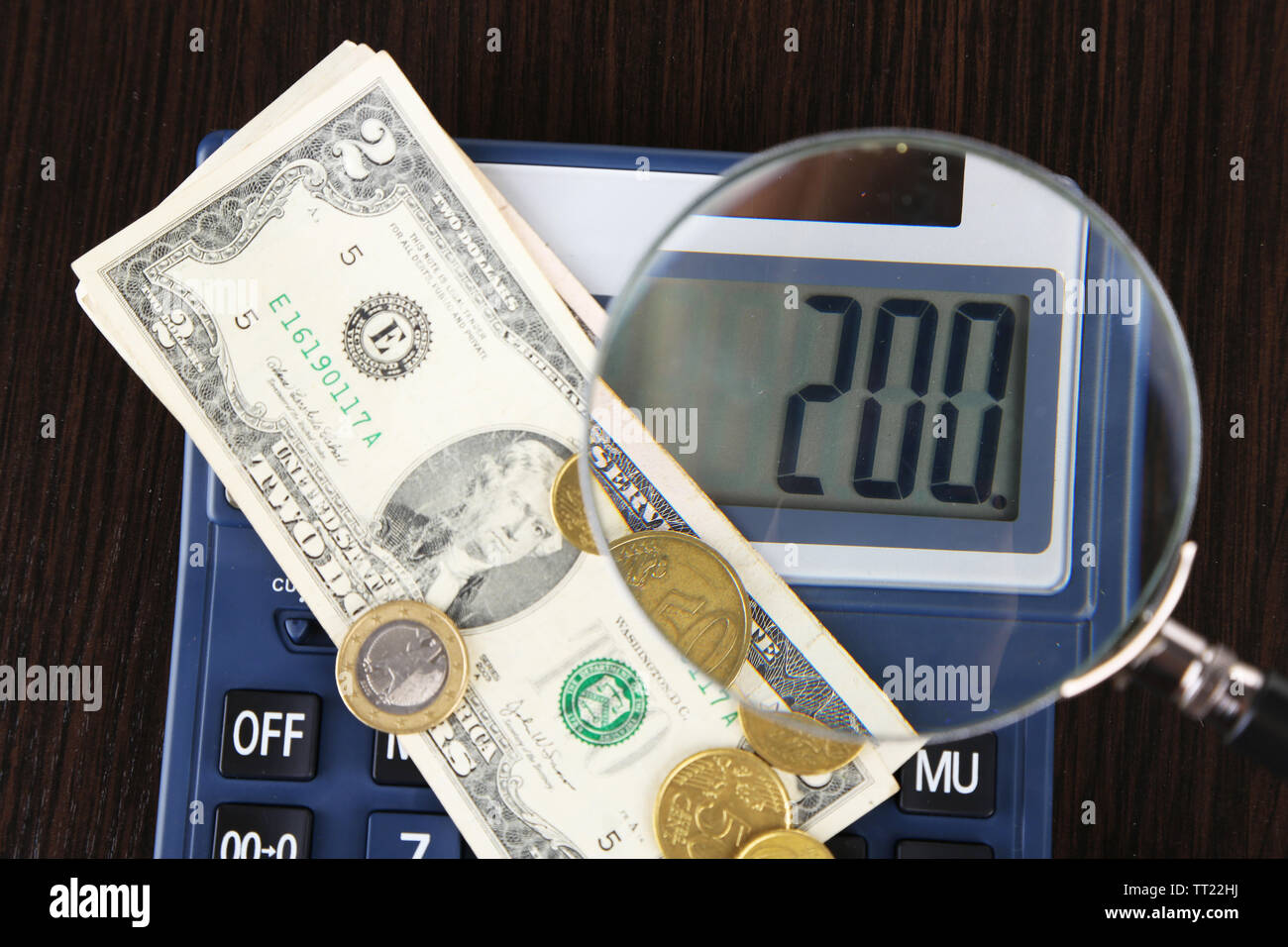 Fraud concept with magnifier and calculator, on wooden background Stock ...
