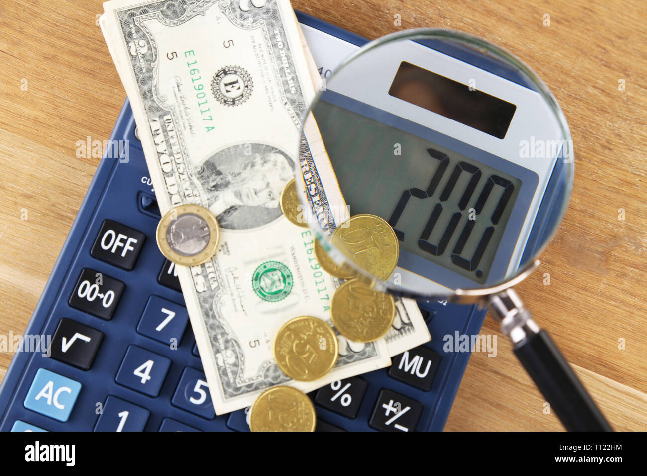 Fraud concept with magnifier and calculator, on wooden background Stock ...