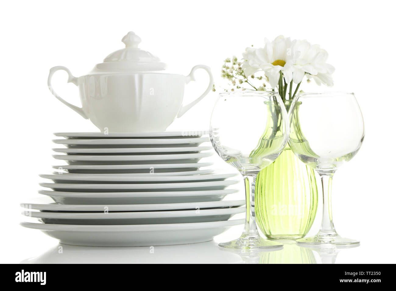 Stack of white ceramic dishes and flowers, isolated on white Stock ...