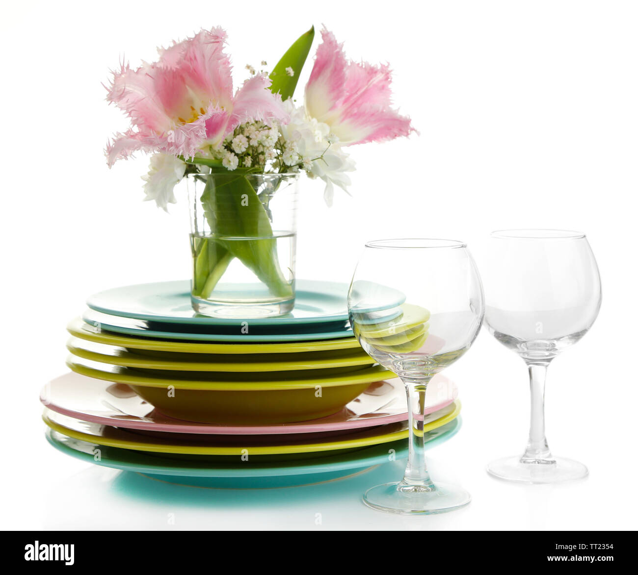 Stack of colorful ceramic dishes and flowers, isolated on white Stock ...