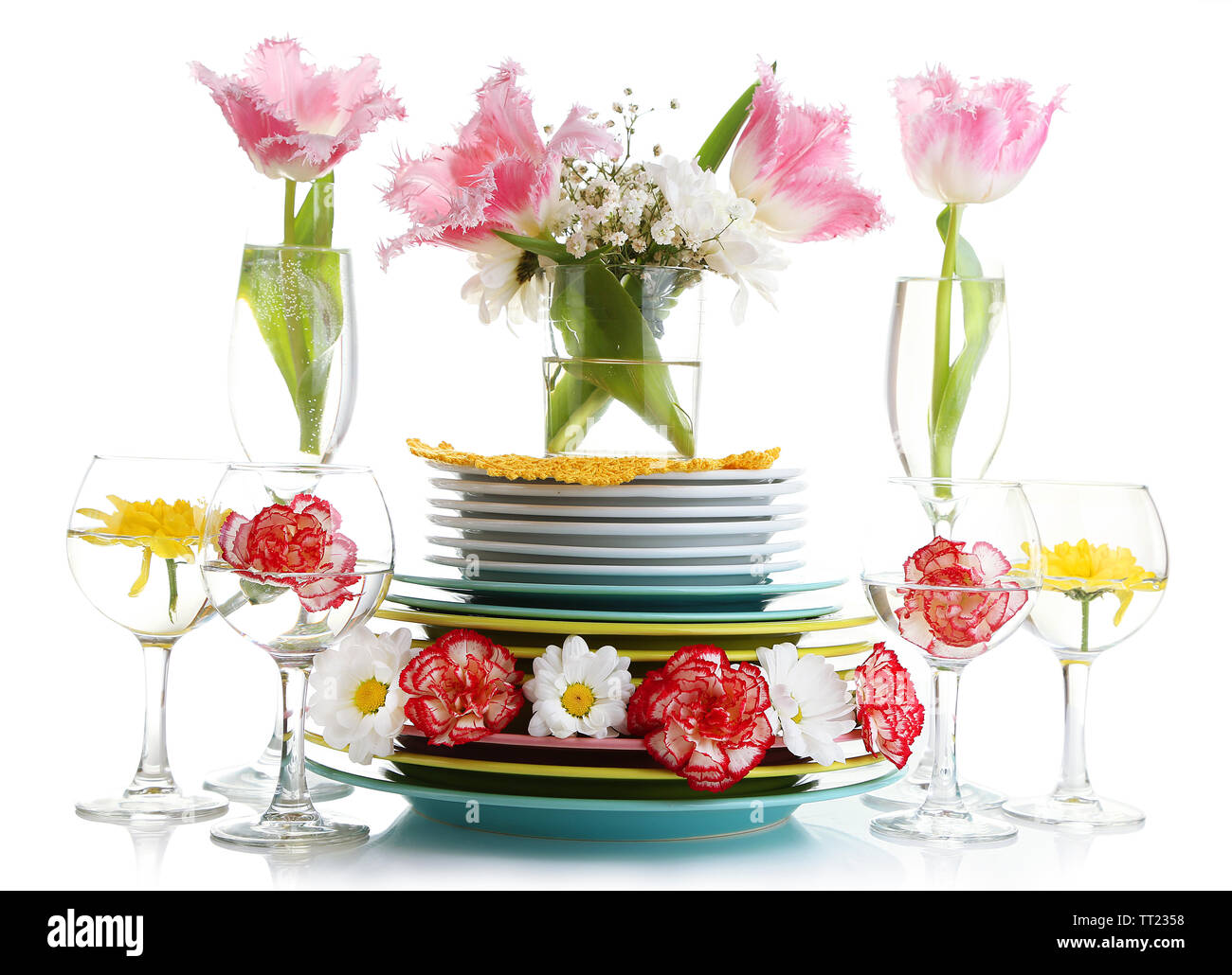 Stack of colorful ceramic dishes and flowers, isolated on white Stock ...