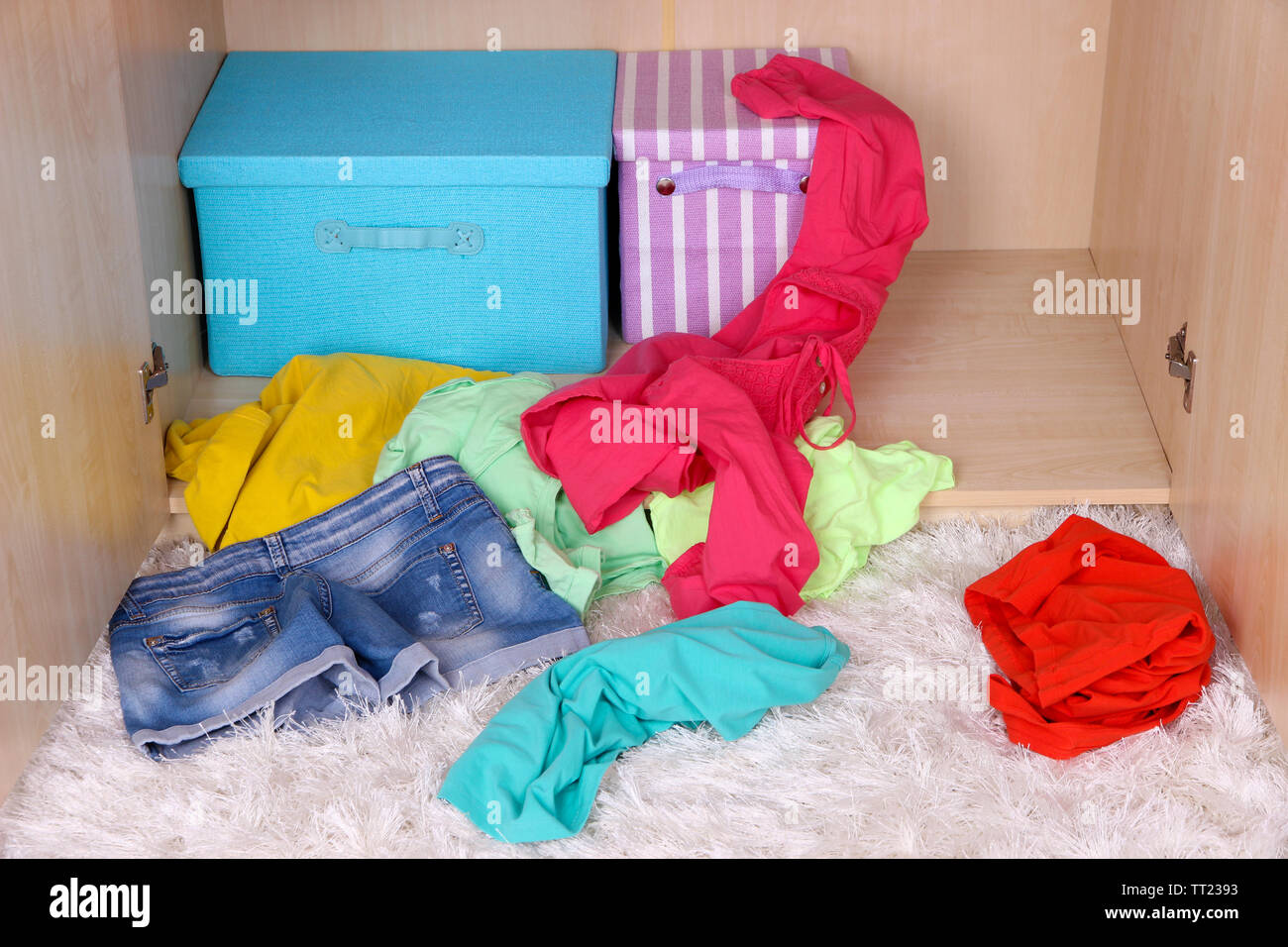 Female clothes lying on floor in room Stock Photo - Alamy
