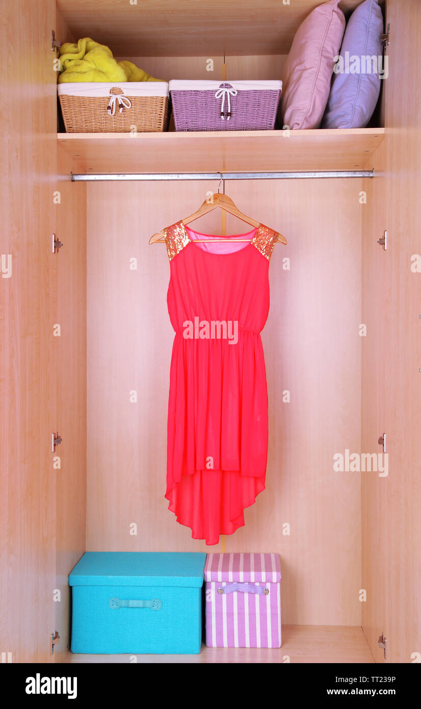 Dress with hangers in wardrobe Stock Photo - Alamy