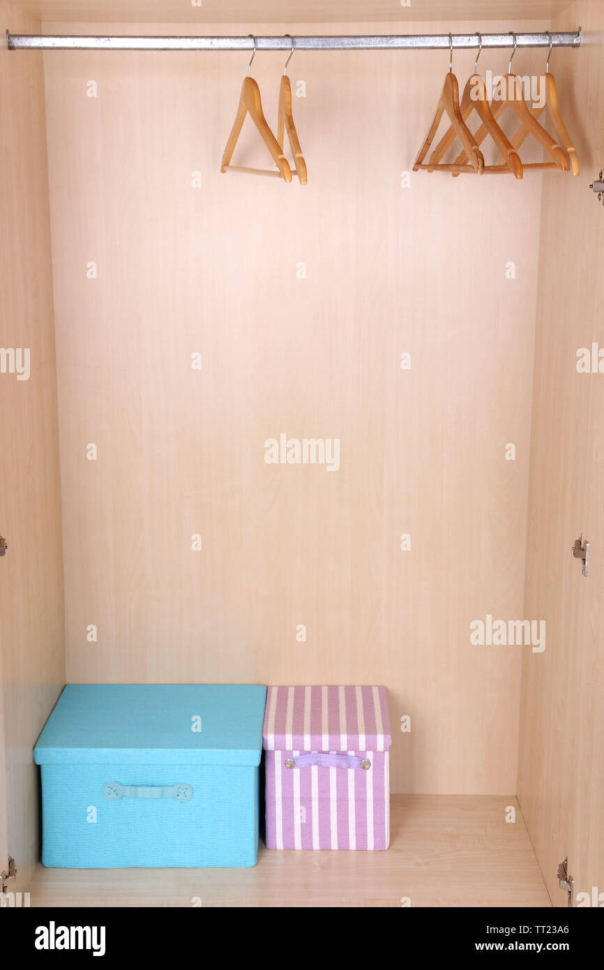 Wooden hangers in wardrobe Stock Photo - Alamy