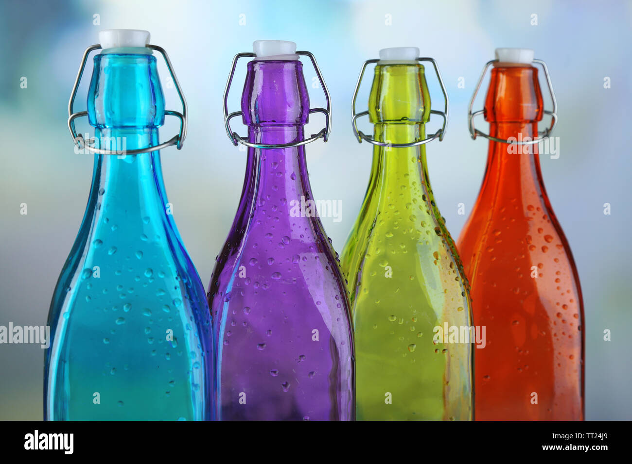 Colorful bottles on light background Stock Photo - Alamy