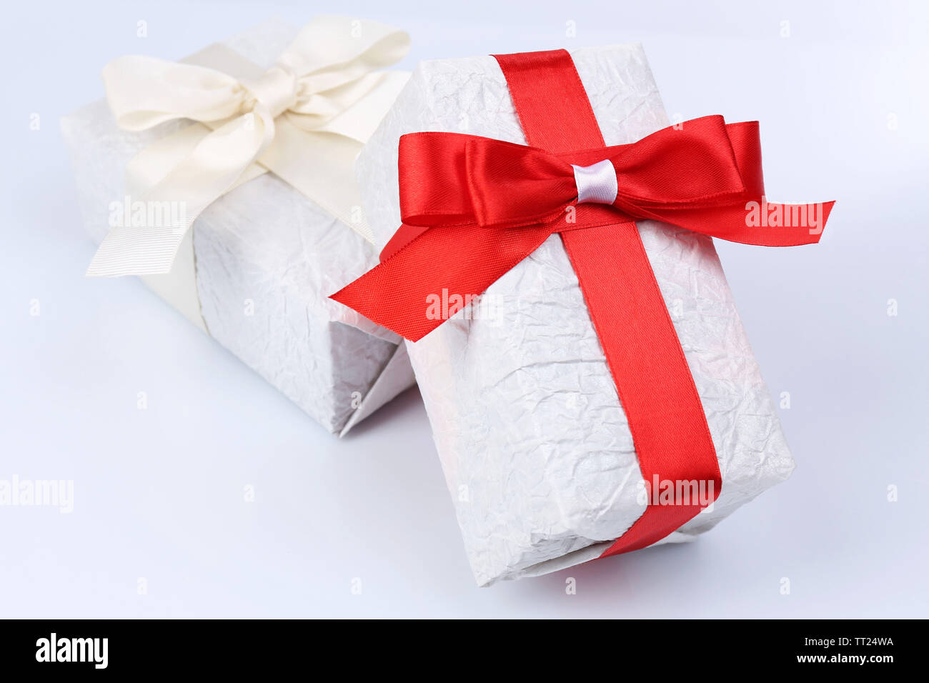 Beautiful gifts with red ribbons, isolated on white Stock Photo - Alamy