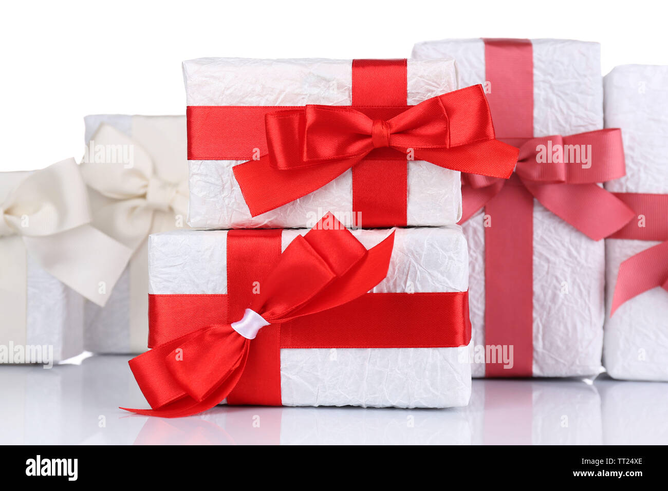 Beautiful gifts with red ribbons, isolated on white Stock Photo - Alamy
